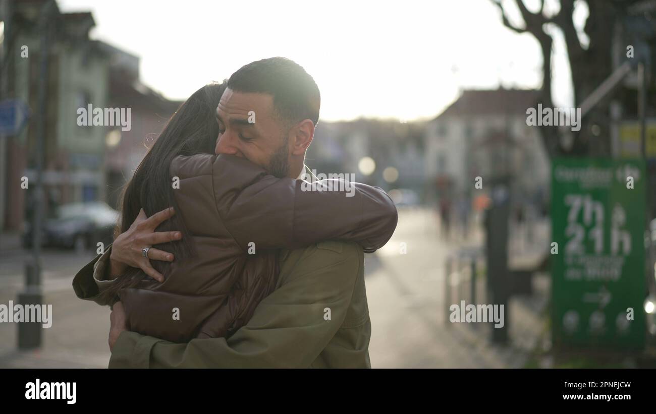 Two friends hug and embrace outside, real life happiness reunion. A ...