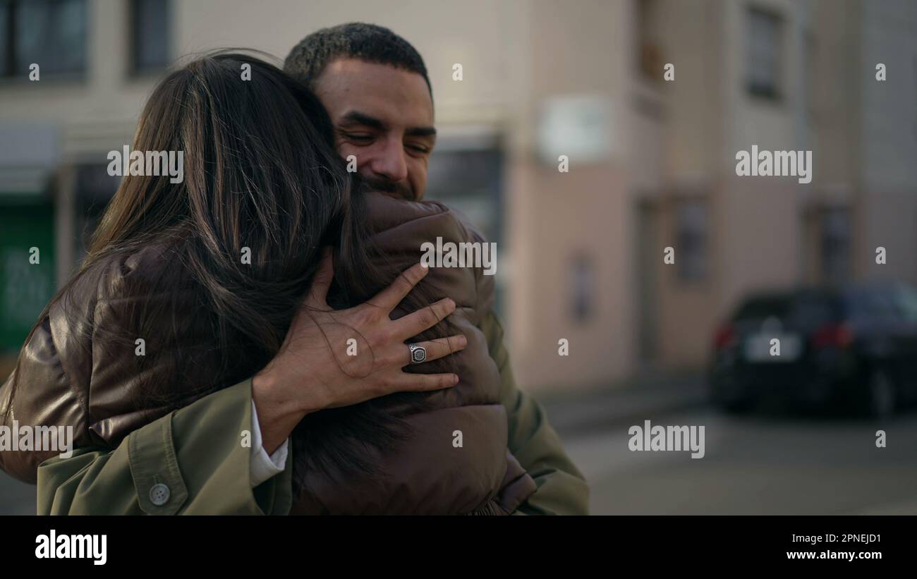 Two friends hug and embrace outside, real life happiness reunion. A ...