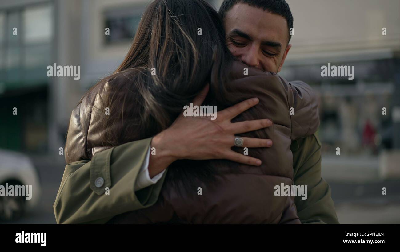 Two friends hug and embrace outside, real life happiness reunion. A ...