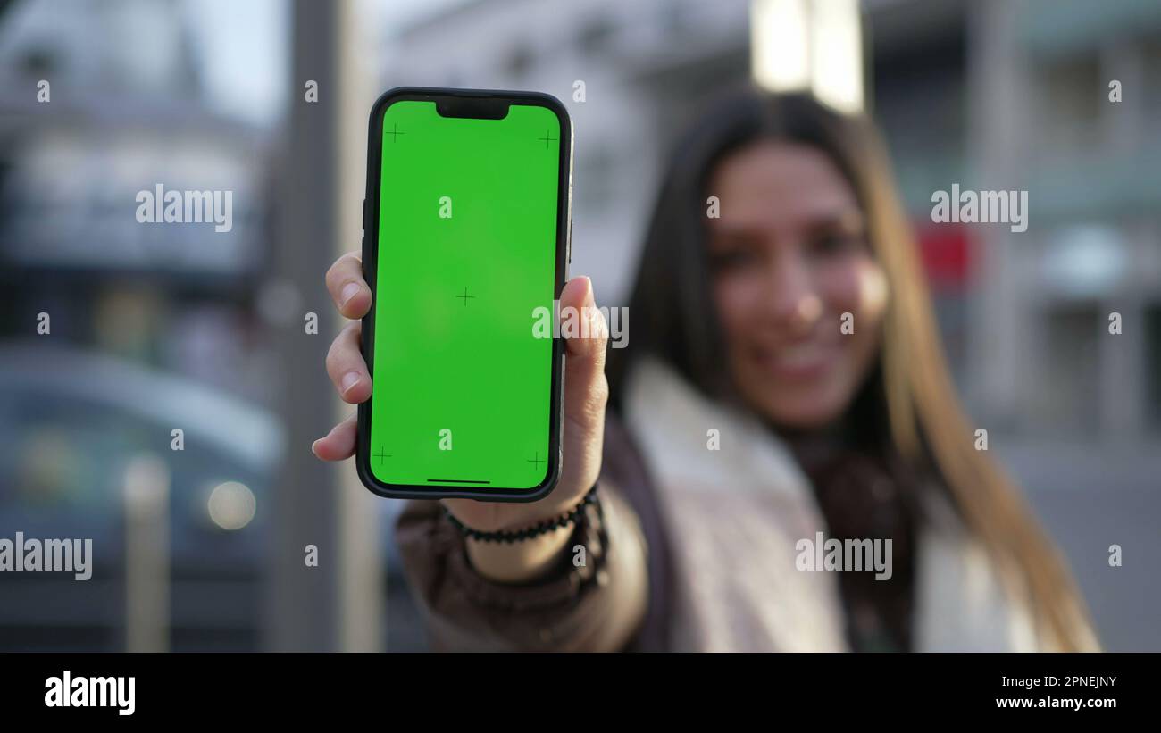 One young woman showing content online to camera while holding ...