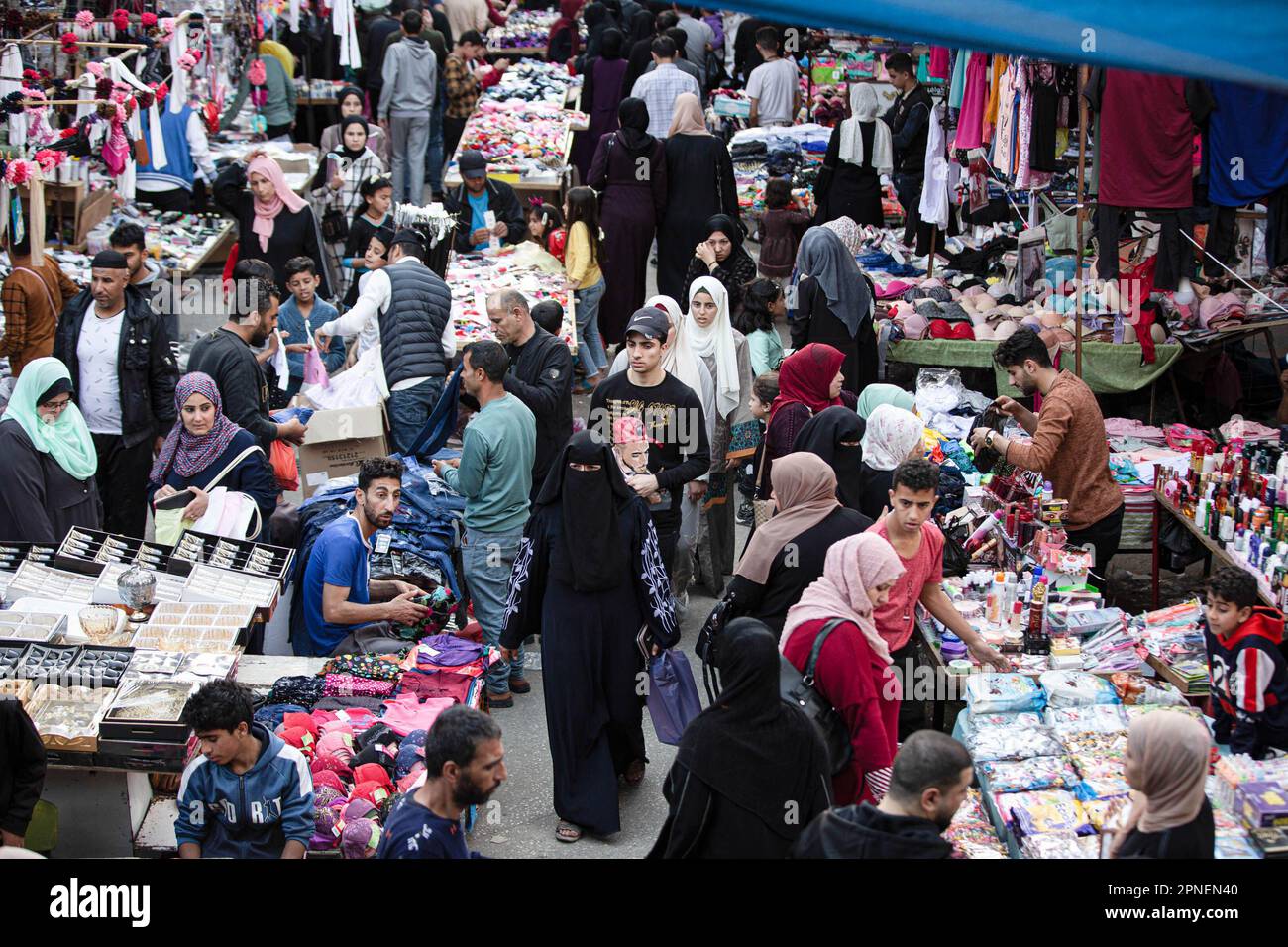 Palestinians make shopping in a local market in Khan Yunis, in the ...