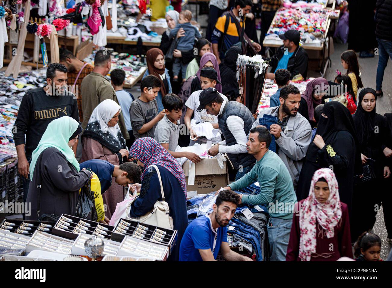 Palestinians make shopping in a local market in Khan Yunis, in the ...