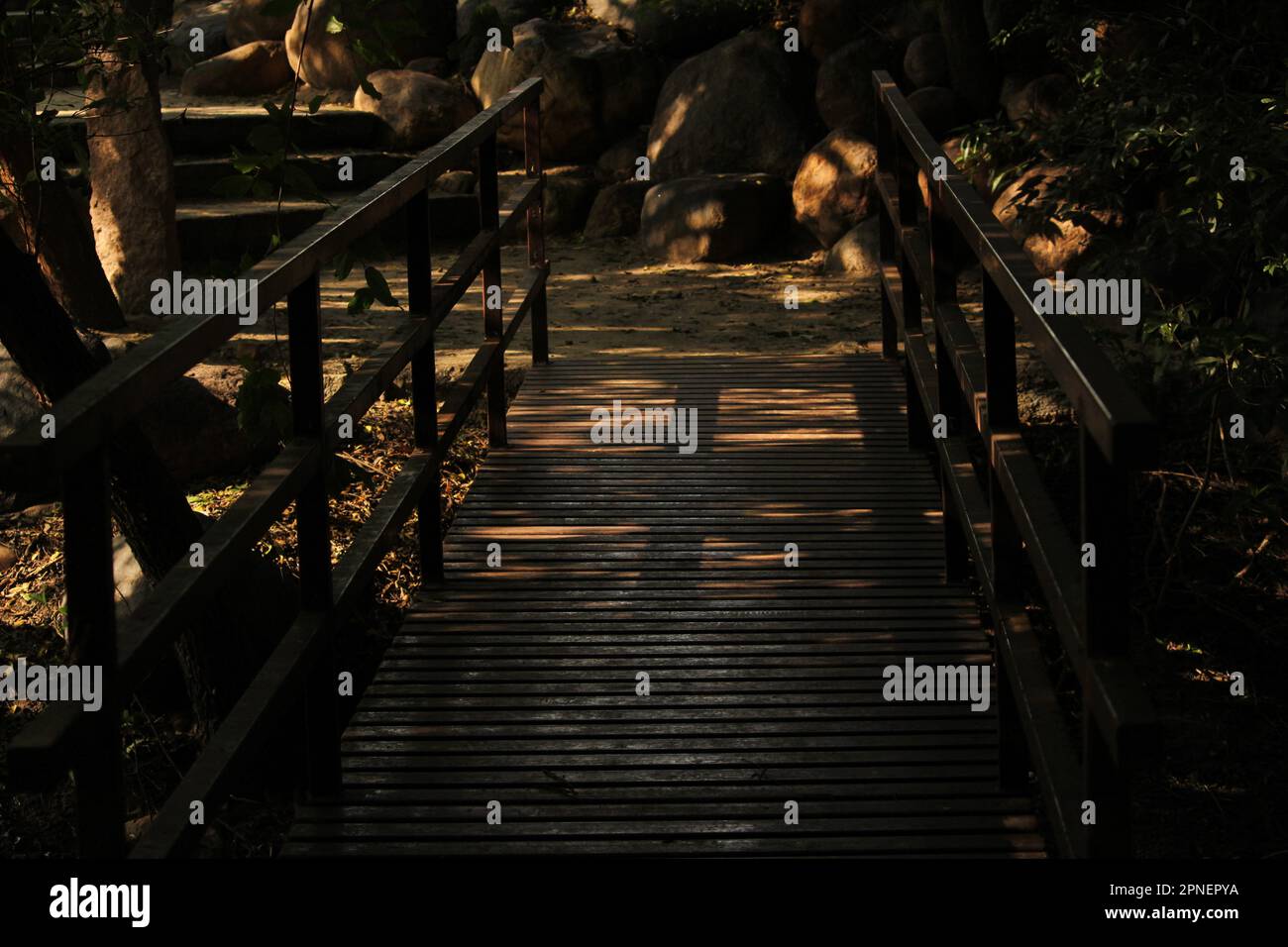 Steel or iron bridge on the garden with sunlight shadow. steel or iron ...