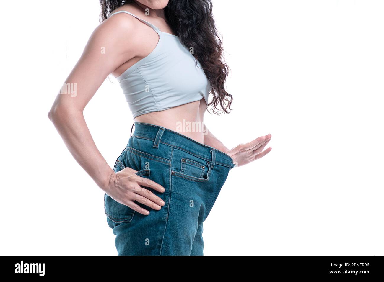 mature beautiful woman measuring her pants and noticing her weight loss ...