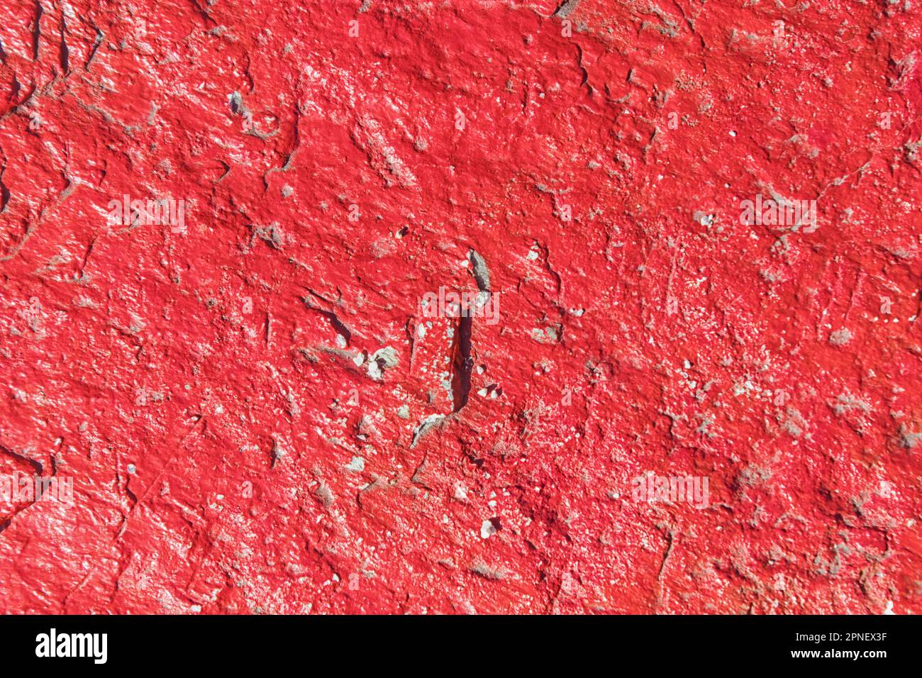 The texture of a stone covered with red paint. Natural background Stock ...
