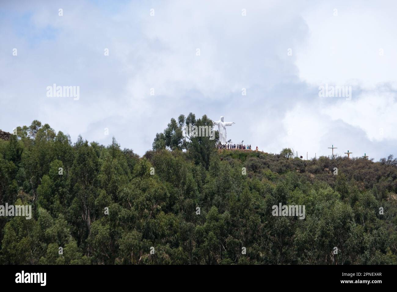 People visiting Jesus statue at Cusco hill. Jesus statue view from low ...