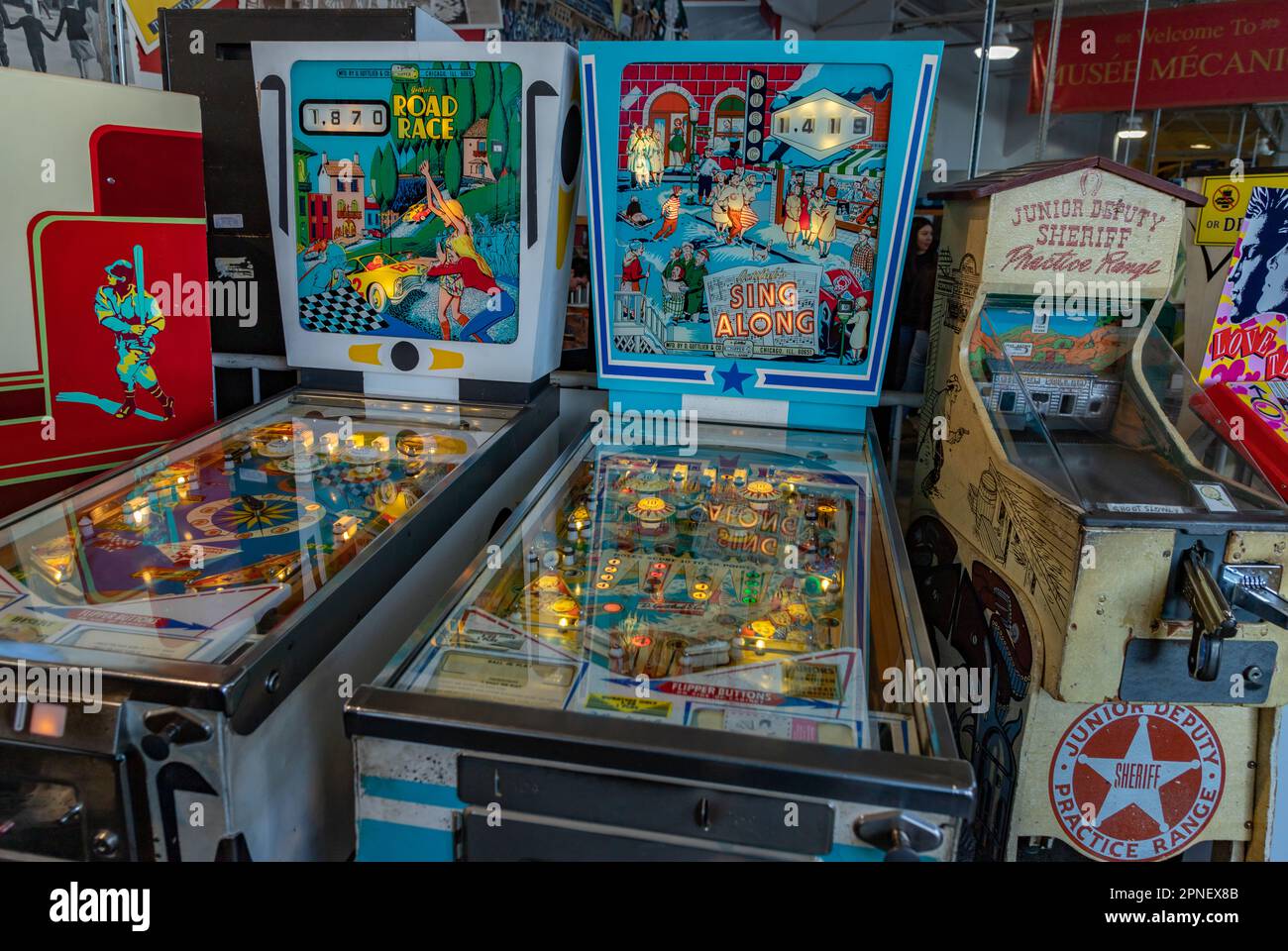 A picture of some retro arcade games, including two pinball machines ...