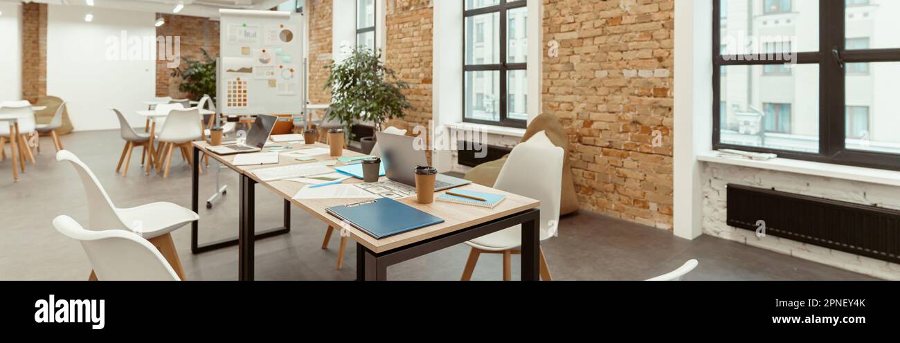 Empty work room in modern coworking in loft style Stock Photo - Alamy