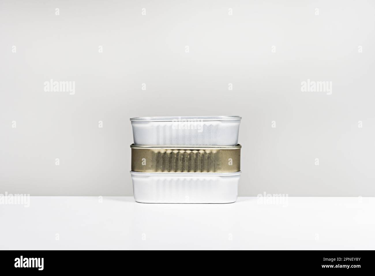 A stack of three canned food tins on a white surface Stock Photo - Alamy
