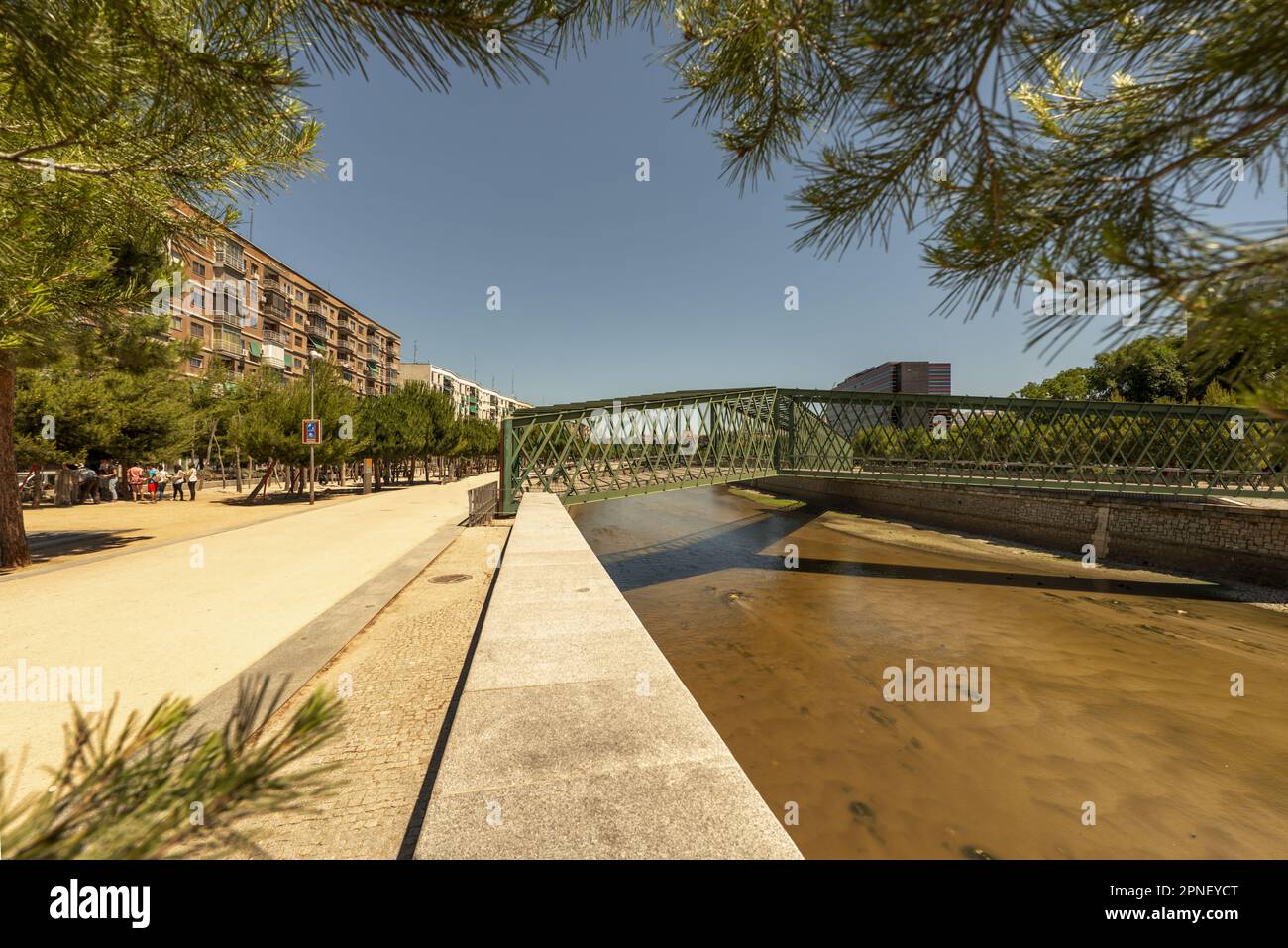 Views of a green painted steel footbridge over the manzanares river in ...
