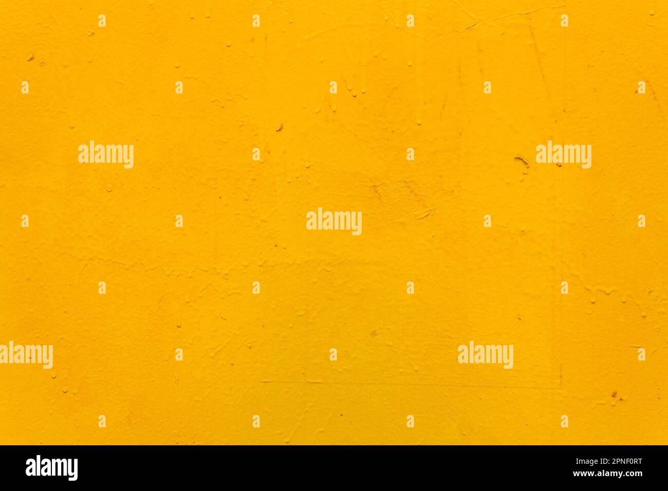 The metal surface is rough, with smudges, painted with yellow paint ...