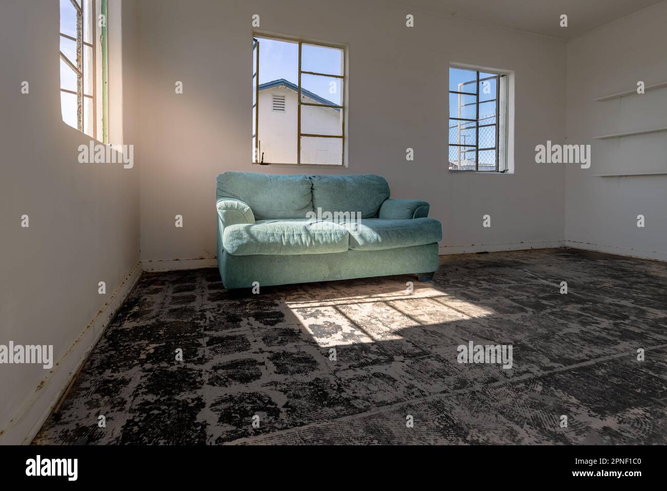An old, dusty couch in a empty motel room Stock Photo - Alamy