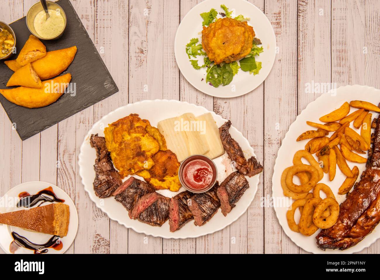 A combination of Colombian gastronomy dishes with charcoal meats, corn ...