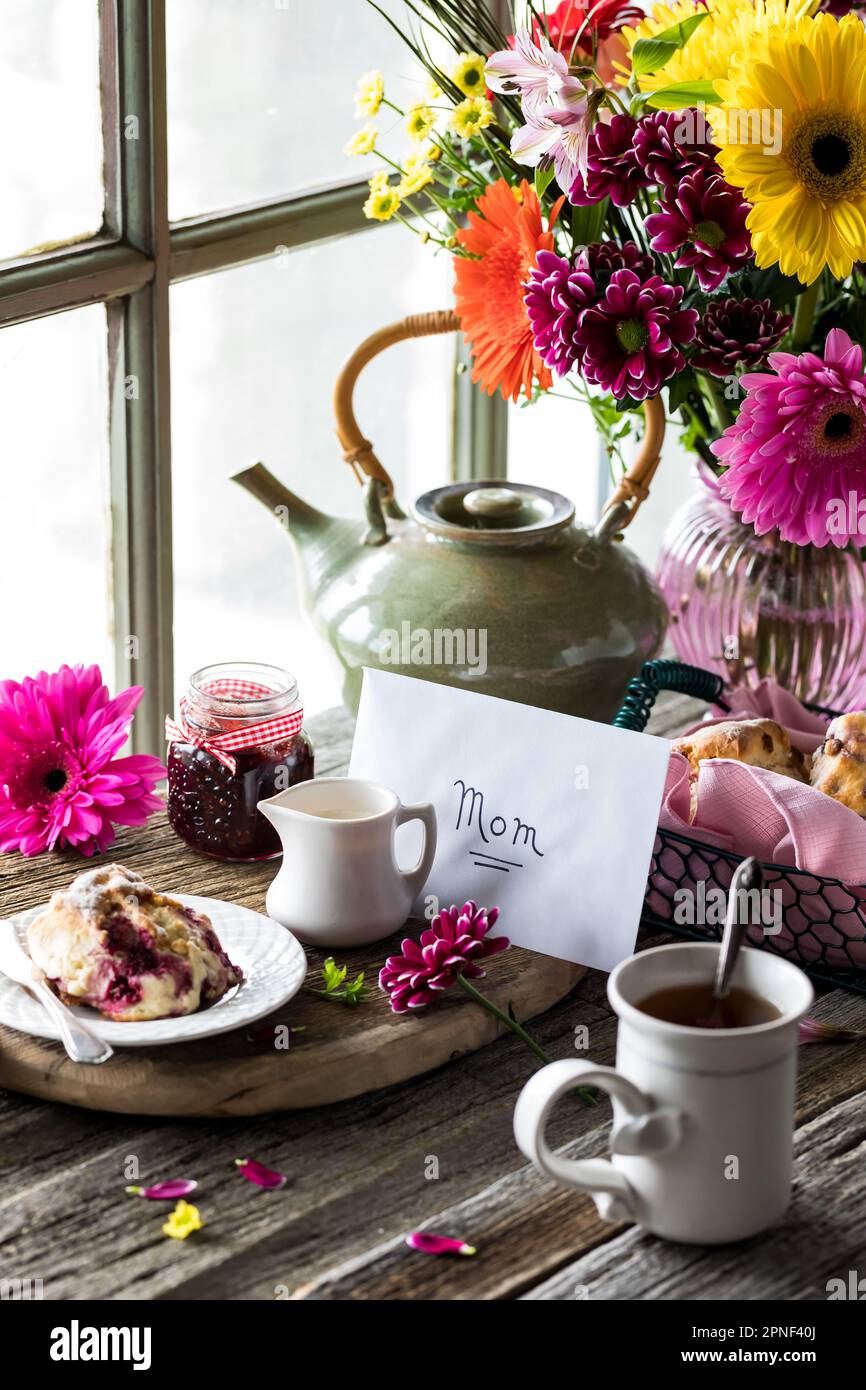 Mother's day arrangement of tea and scones with pretty flowers in ...