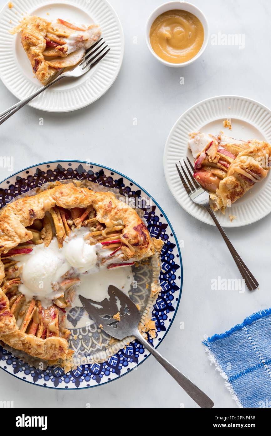 Salted caramel apple galette topped with vanilla ice cream and plated ...