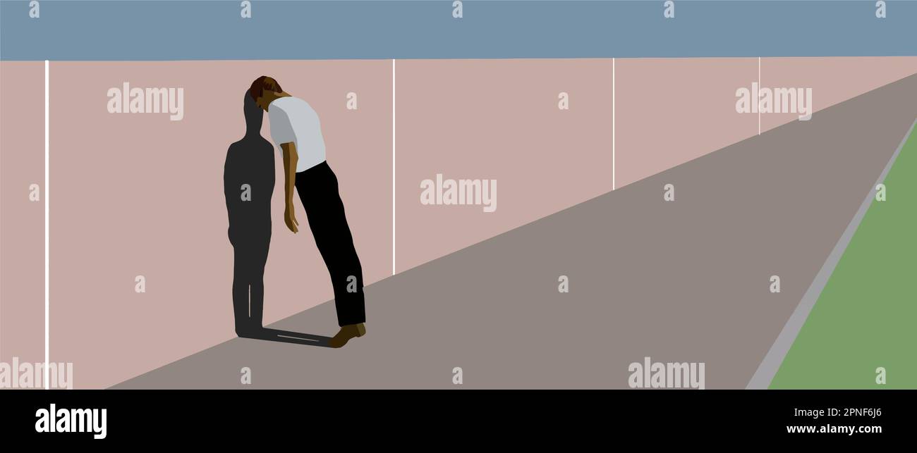 A frustrated and overwhelmed man leans his head against a wall in a ...