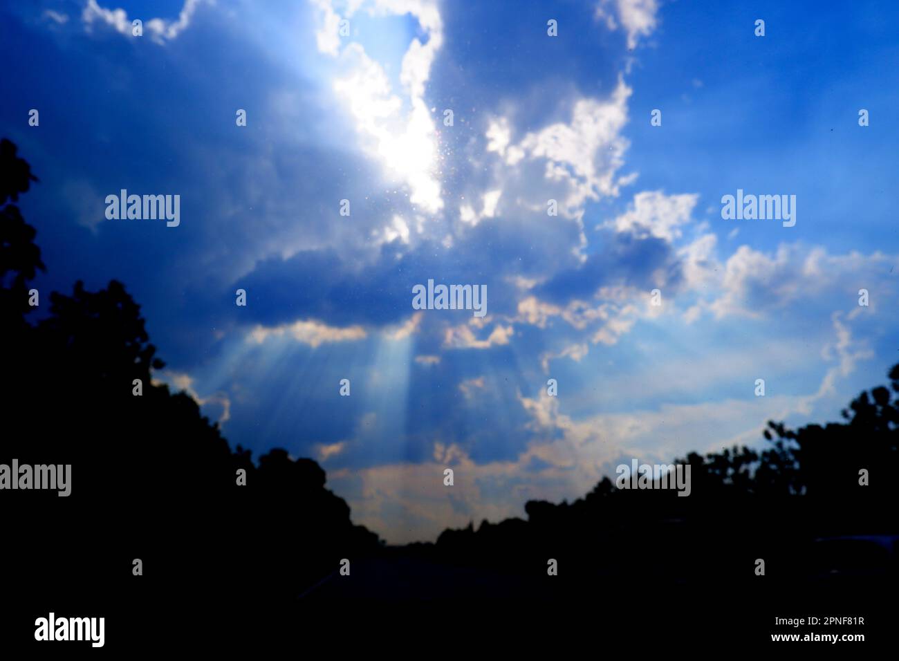 Defocused Sun Ray Light Through Cloud on Blue Sky : can be used as ...