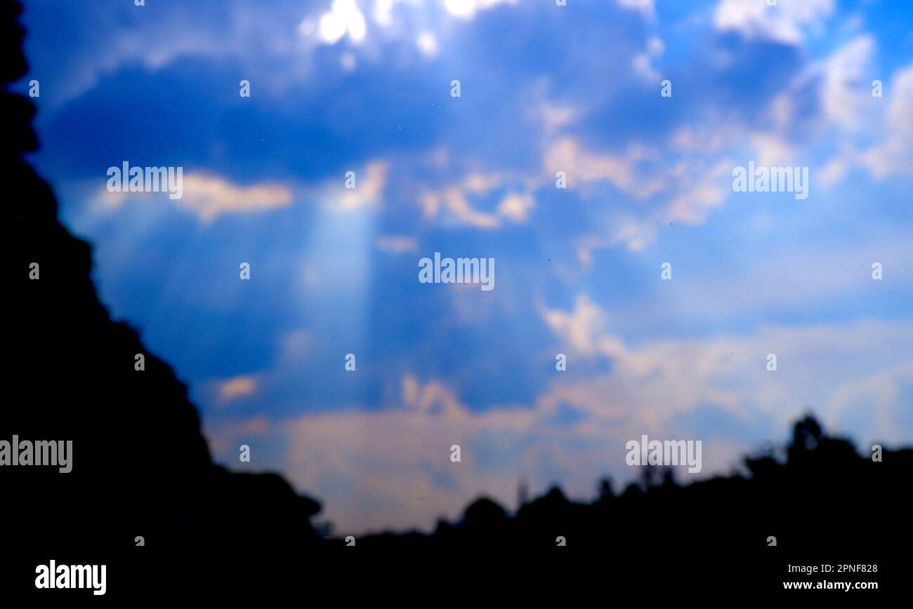 Defocused Sun Ray Light Through Cloud on Blue Sky : can be used as ...