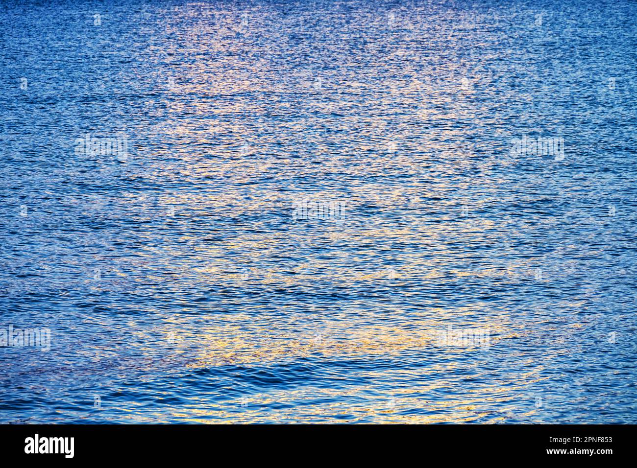 Calm ocean surface reflecting sunlight Stock Photo - Alamy