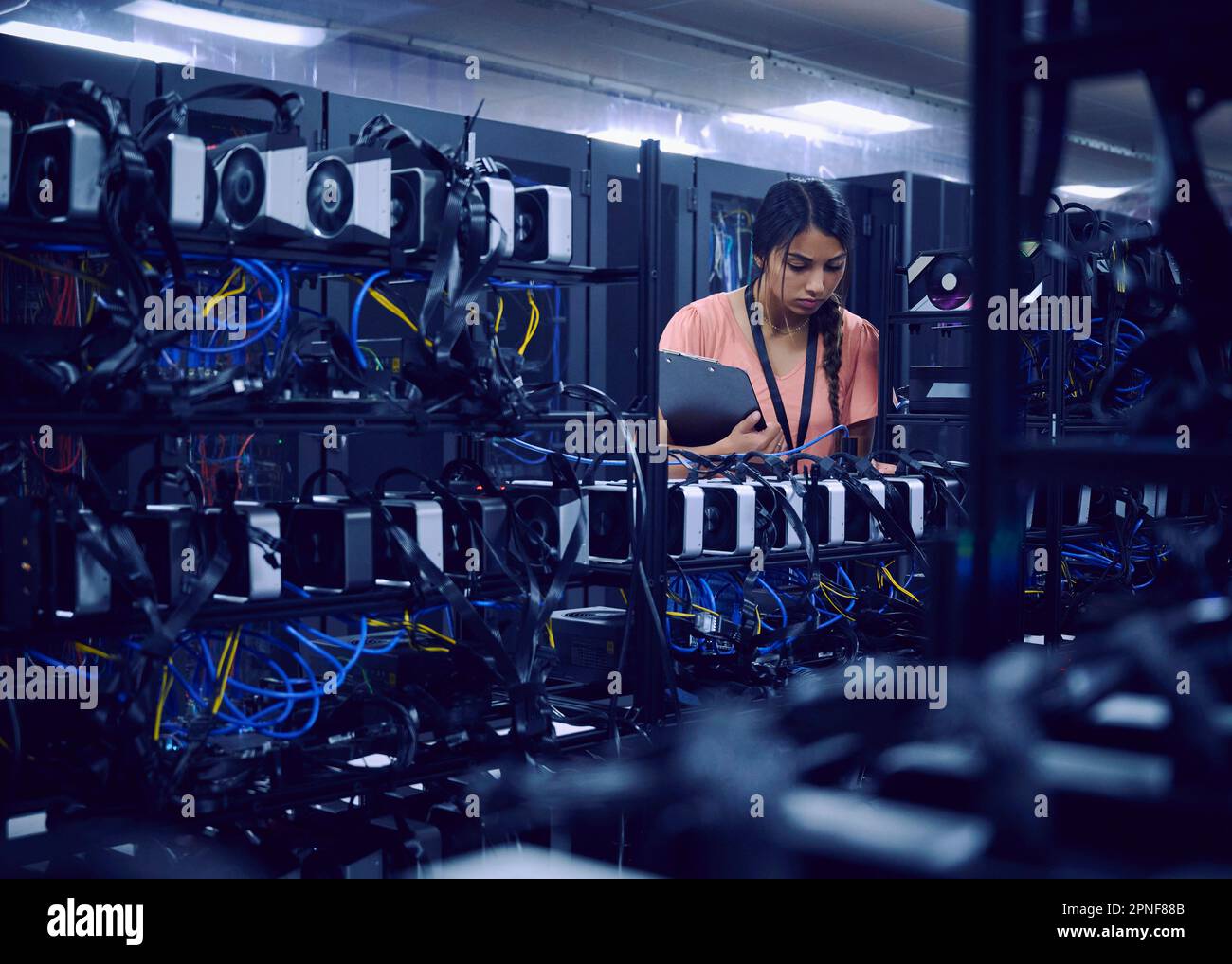 Female technician working in server room Stock Photo - Alamy