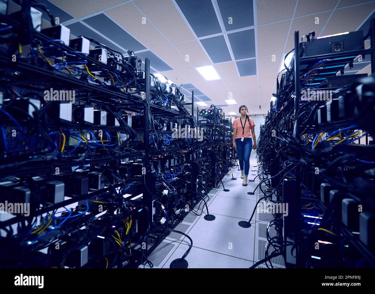 Female technician working in server room Stock Photo - Alamy