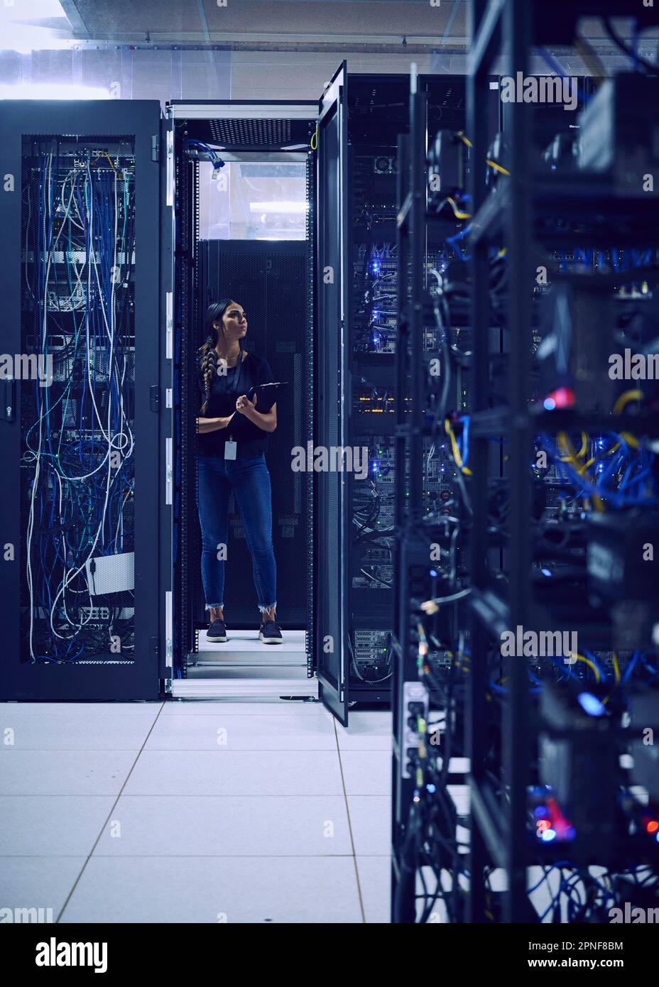 Female technician working in server room Stock Photo - Alamy