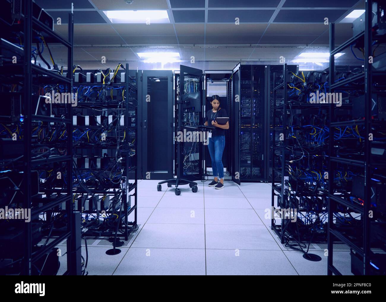 Female technician working in server room Stock Photo - Alamy