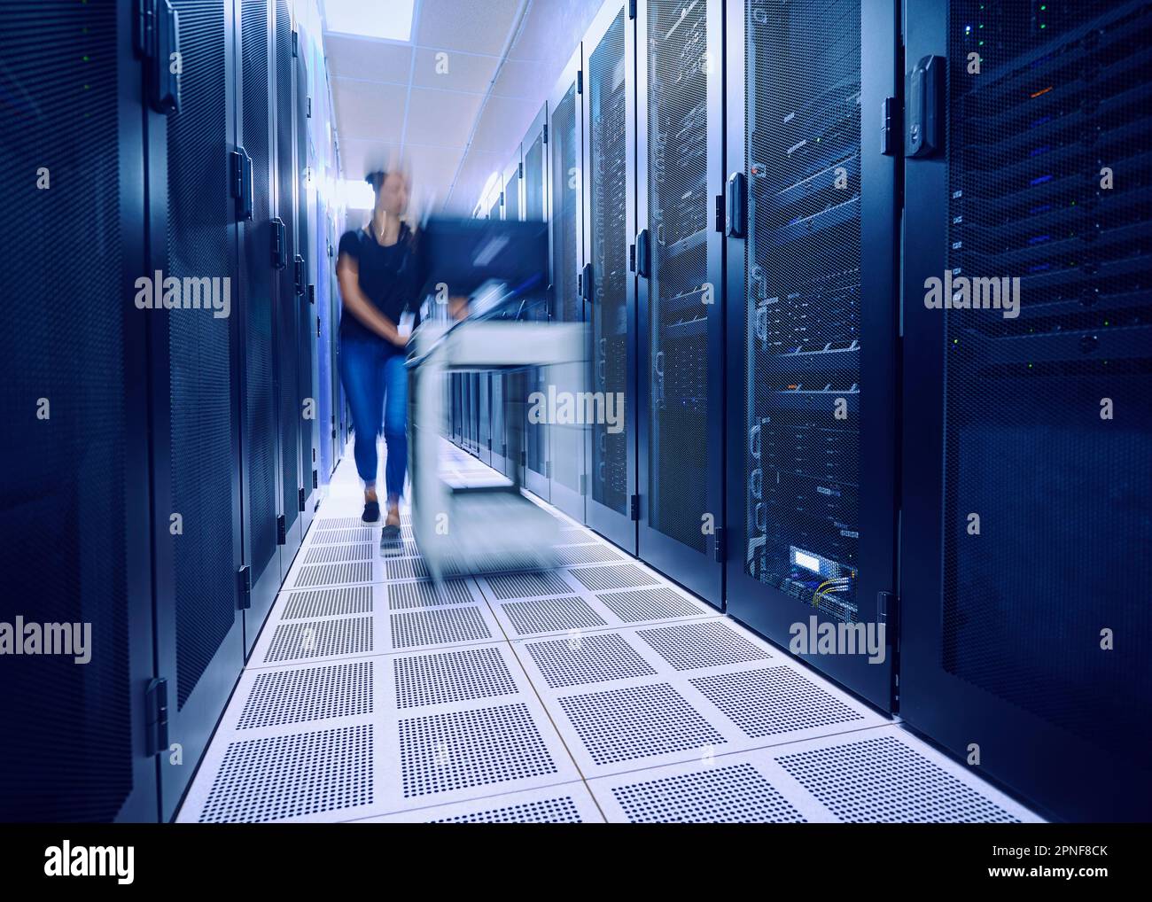 Female technician pushing cart in server room Stock Photo - Alamy