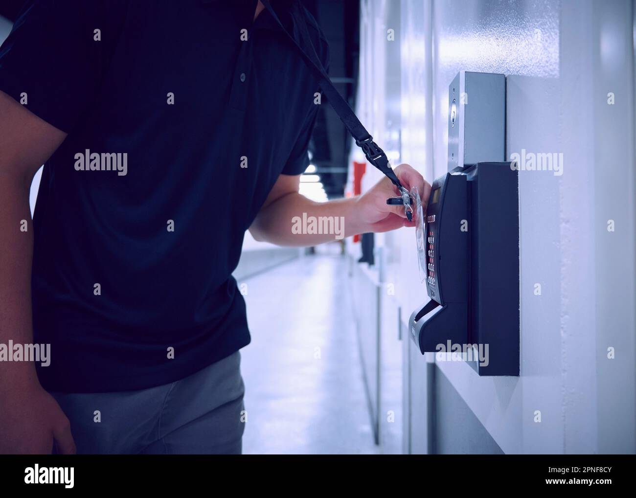 Midsection of man using security card to enter room in data center ...