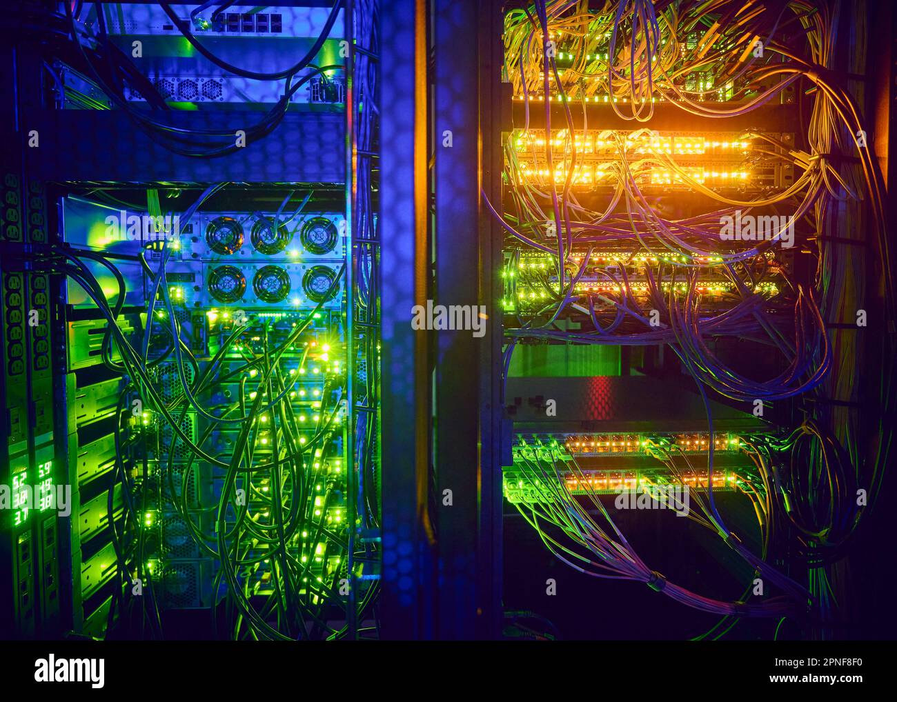 Illuminated servers and computer cables in server room Stock Photo - Alamy