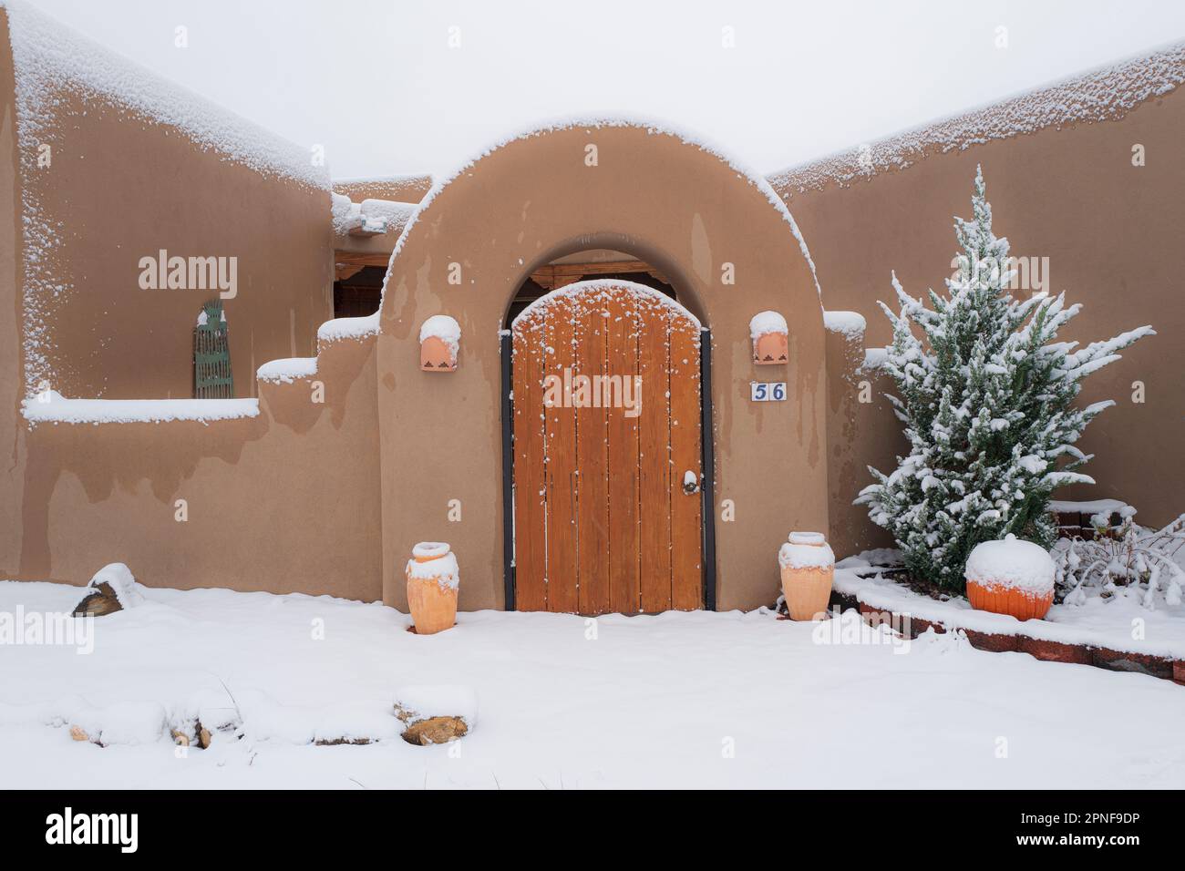 United States, New Mexico, Santa Fe, Autumn snow at front of Pueblo ...