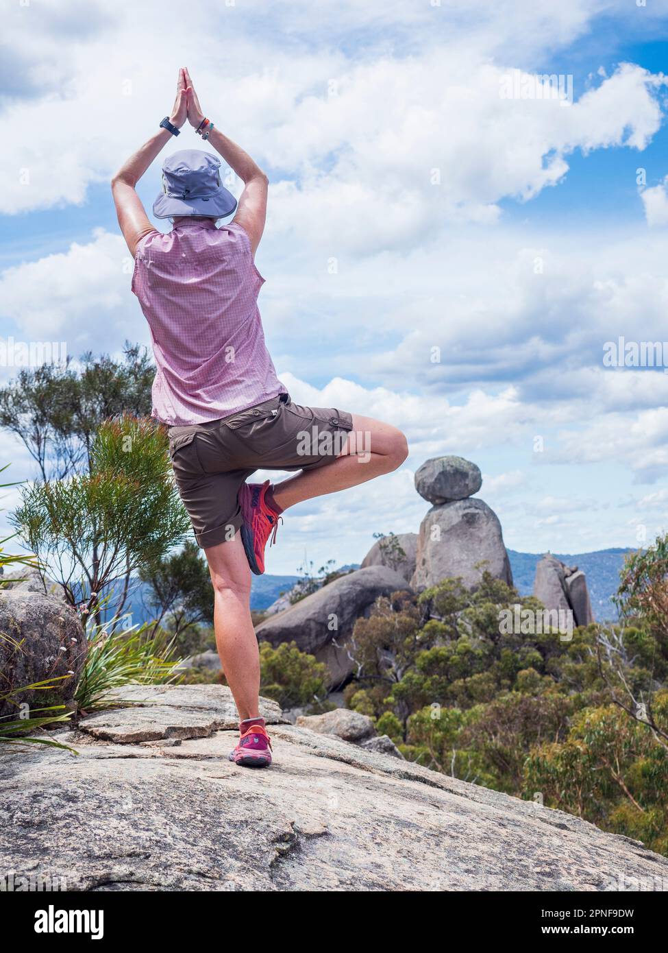 Australia, Queensland, Girraween National Park, Woman practincing tree ...