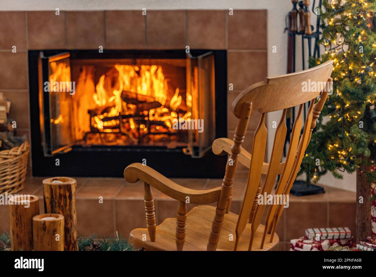 Holiday living room with fireplace and wooden rocking chair Stock Photo ...