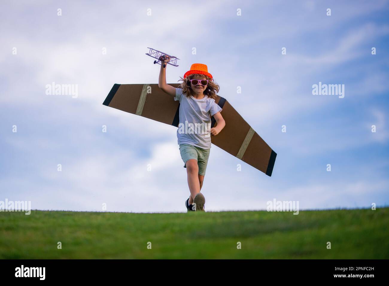 Child boy toddler playing with toy airplane wings and dreaming future ...