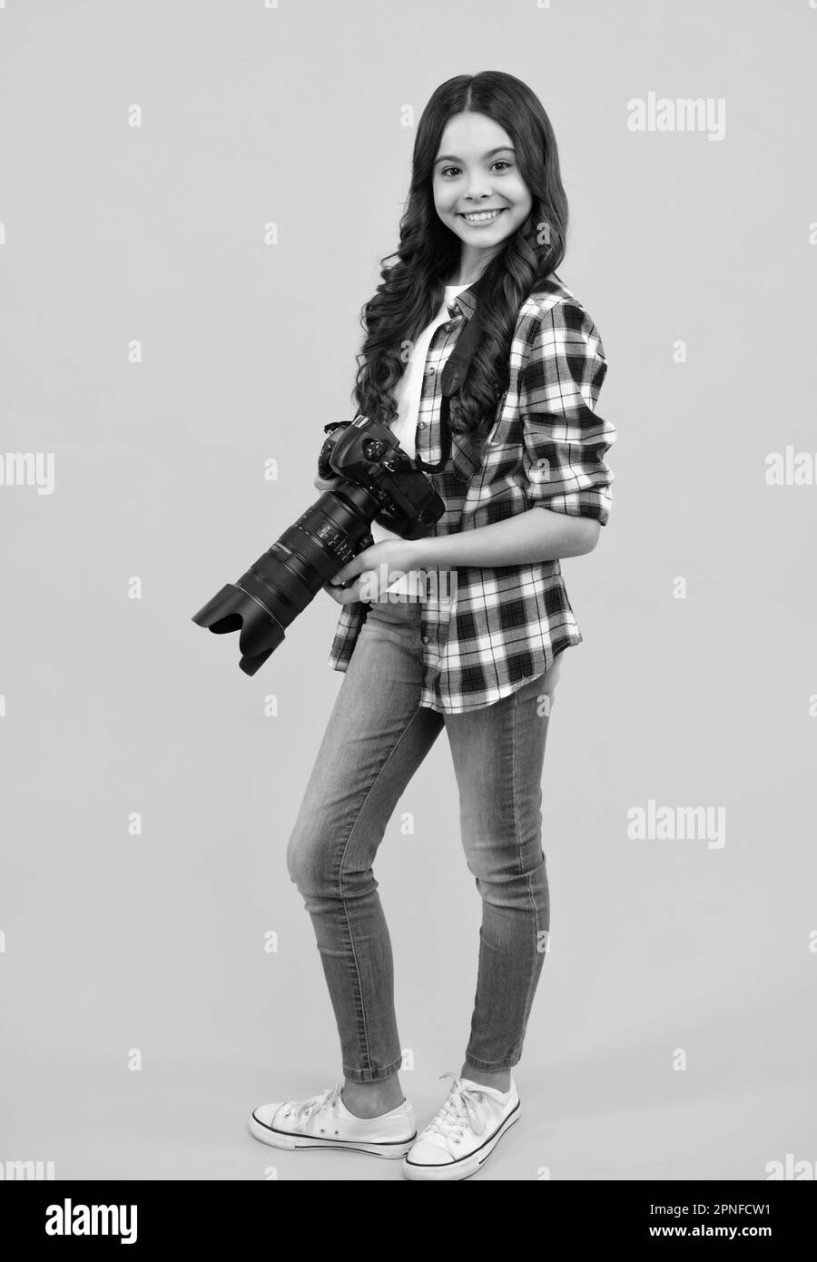 Teenager girl with dslr photo camera with zoom lens. Child photographer ...