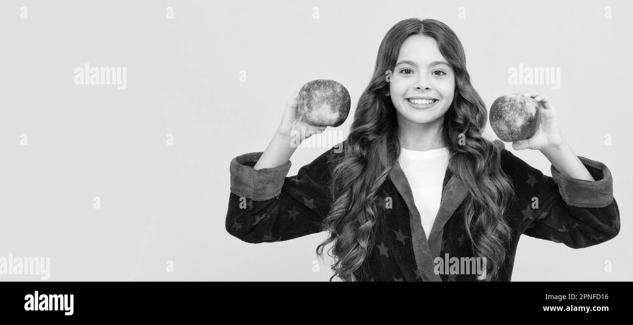 cheerful teen girl with curly hair in comfortable pajama going to eat ...