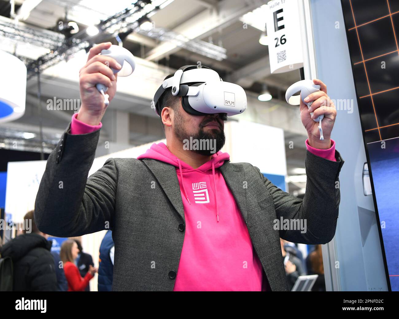 Hannover, Germany. 18th Apr, 2023. A man tries on a VR headset during the Hannover Messe in ...
