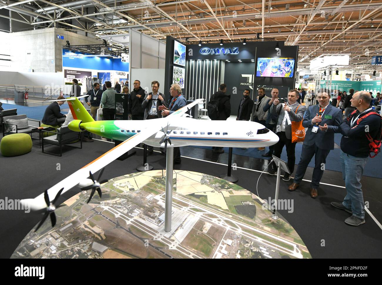 Hannover, Germany. 18th Apr, 2023. People look at a model of hydrogen-powered plane during the ...