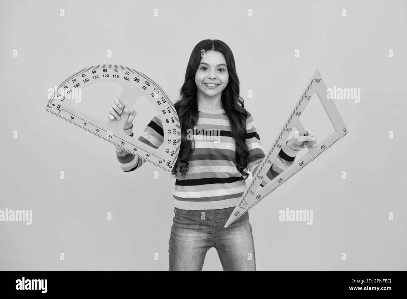 Measuring school equipment. Schoolgirl holding measure for geometry ...