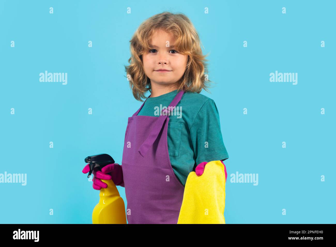 Kid helping with housework, cleaning. Studio portrait of child helping ...
