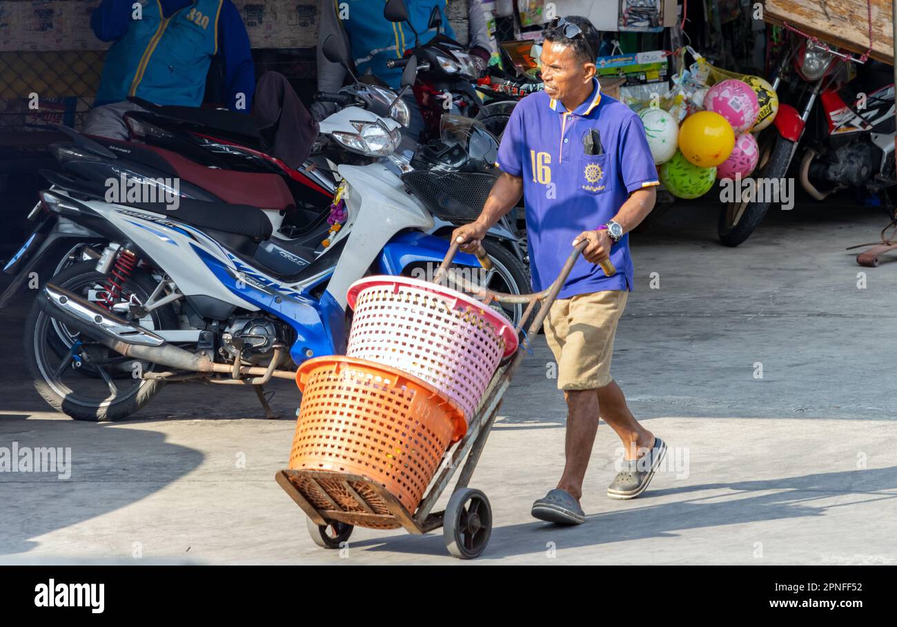 SAMUT PRAKAN, THAILAND, APR 07 2023, Worker push a cart with the ...