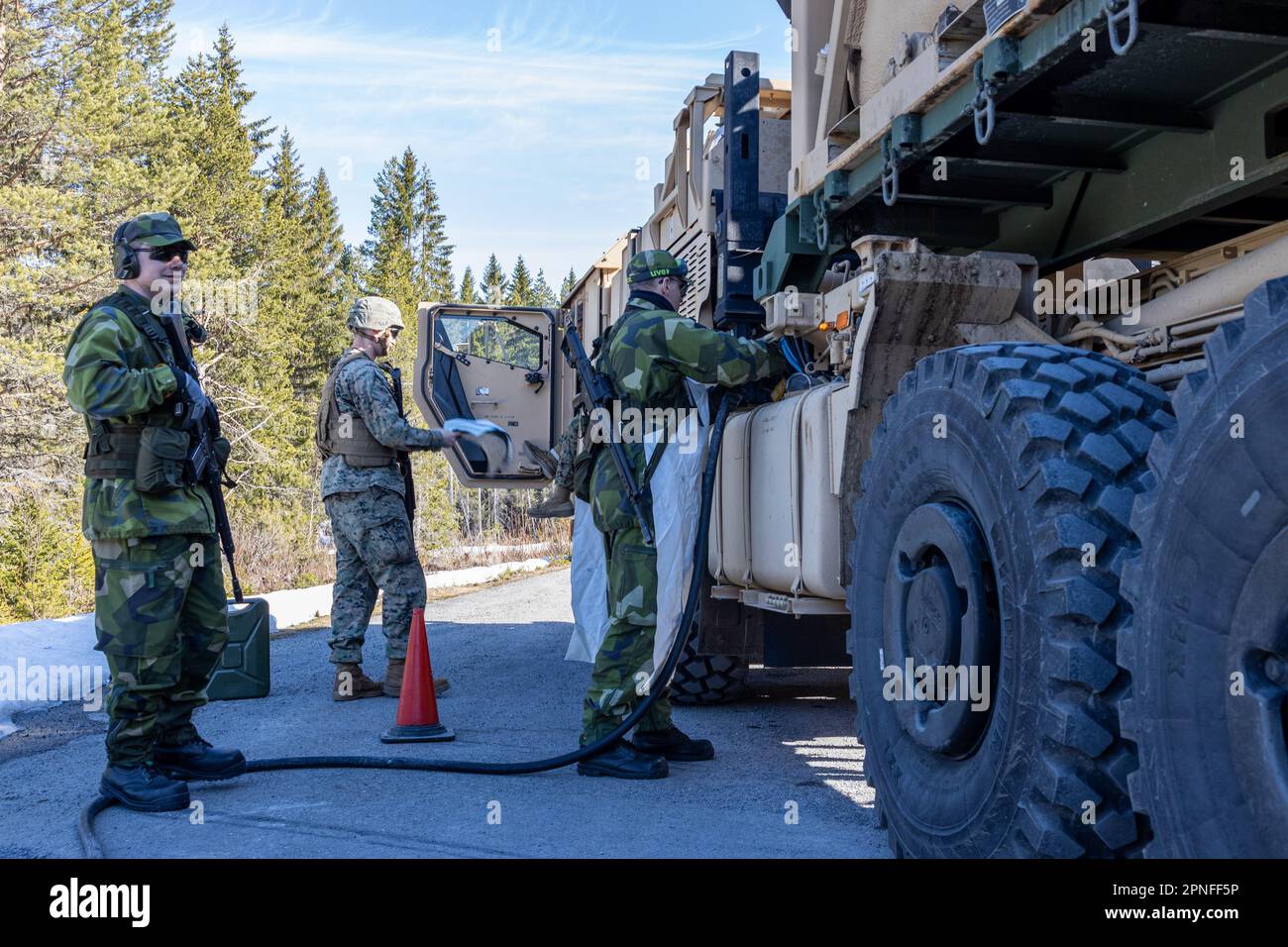 A Swedish soldier refuels a Logistics Vehicle System Replacement near ...