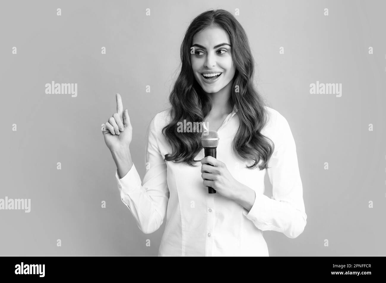 Woman speech, business woman holding a microphone. Young woman talking ...