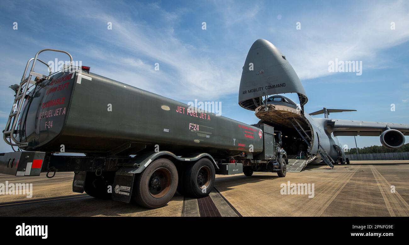 An R-11 fuel truck rolls toward the mouth of a C-5 Super Galaxy to be ...