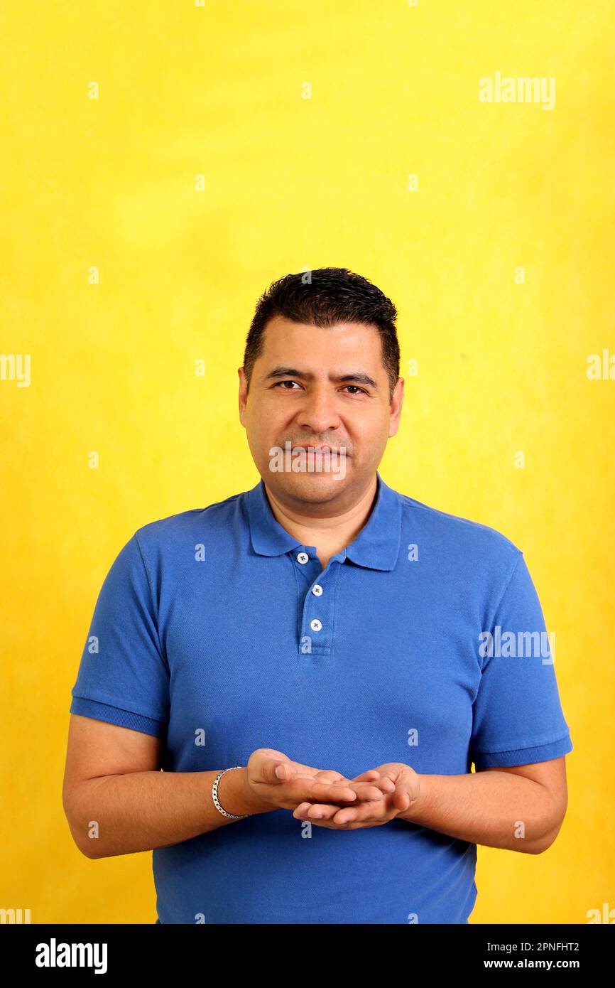 Dark-haired Latino adult man uses sign language typical of deaf people ...