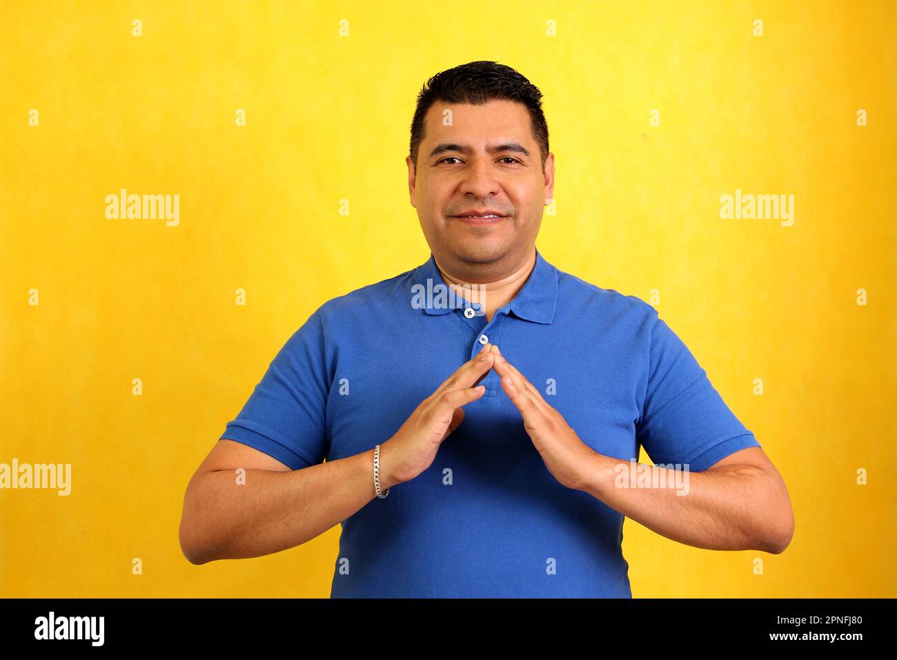 Dark-haired Latino adult man uses sign language typical of deaf people ...