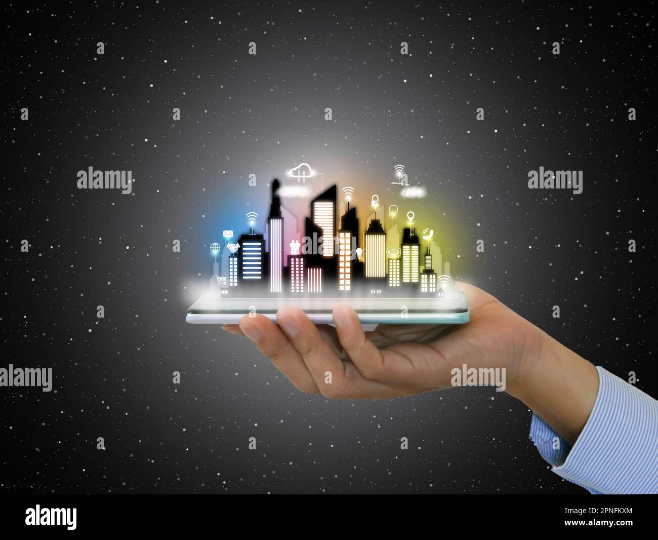 A hand holding a smartphone with virtual Smart City on it, night scene ...