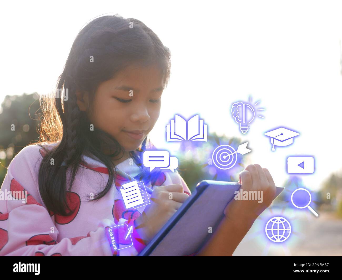 Asian girl using a tablet connected to internet for her education: e-learning, studying, reading ...