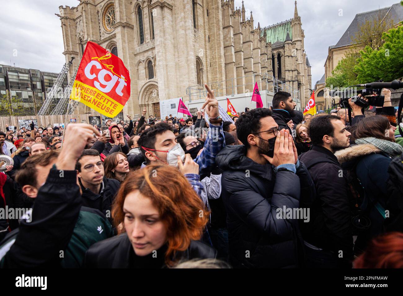Paris, France. 18th Apr, 2023. A crowd of protesters holds flags and ...