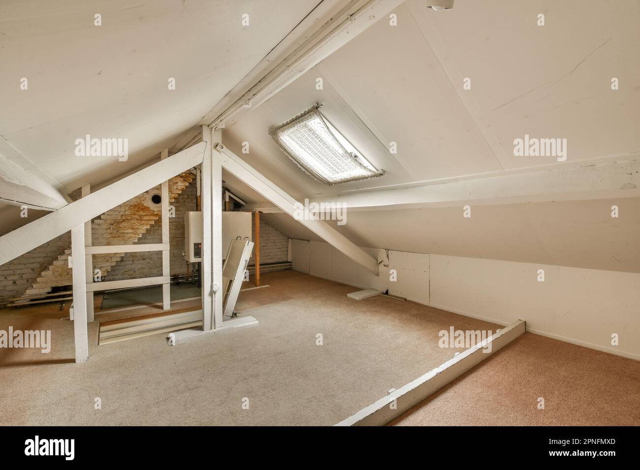 an attic room with no one on the floor, and there is a window in the ...